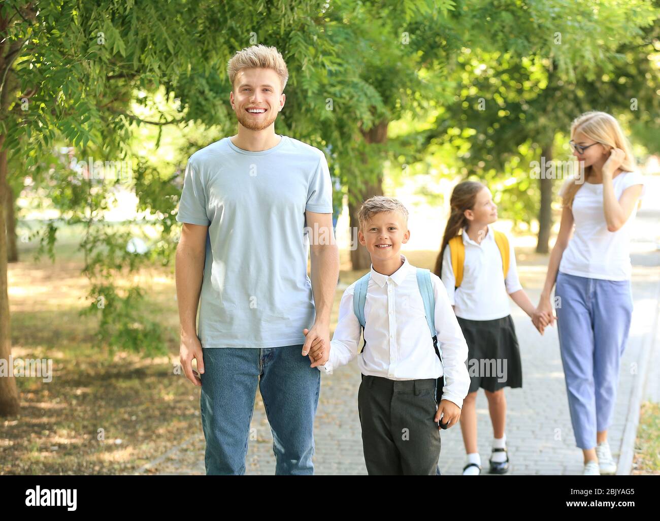 Little children going to school with their parents Stock Photo - Alamy