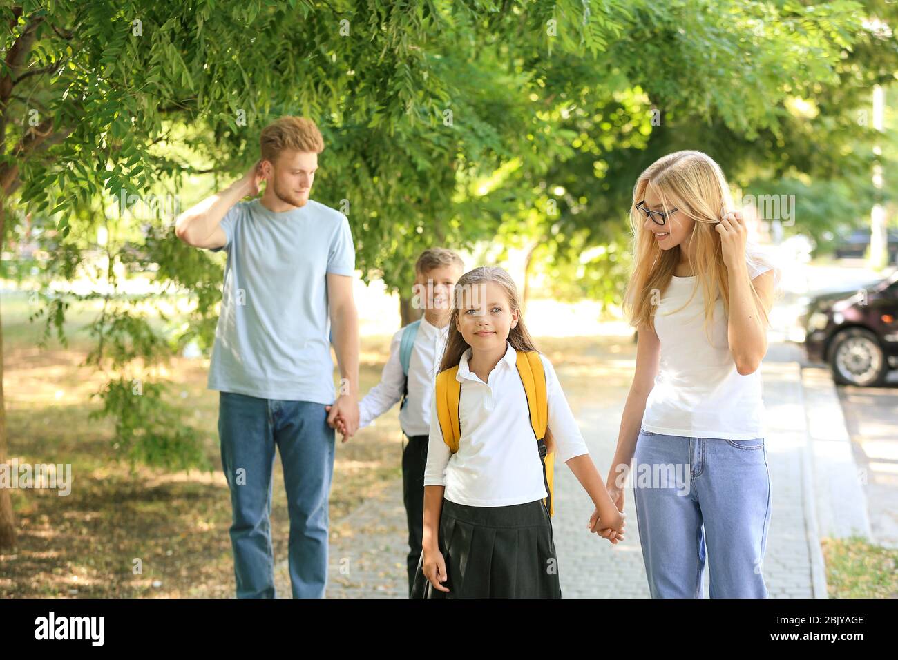 Little children going to school with their parents Stock Photo - Alamy
