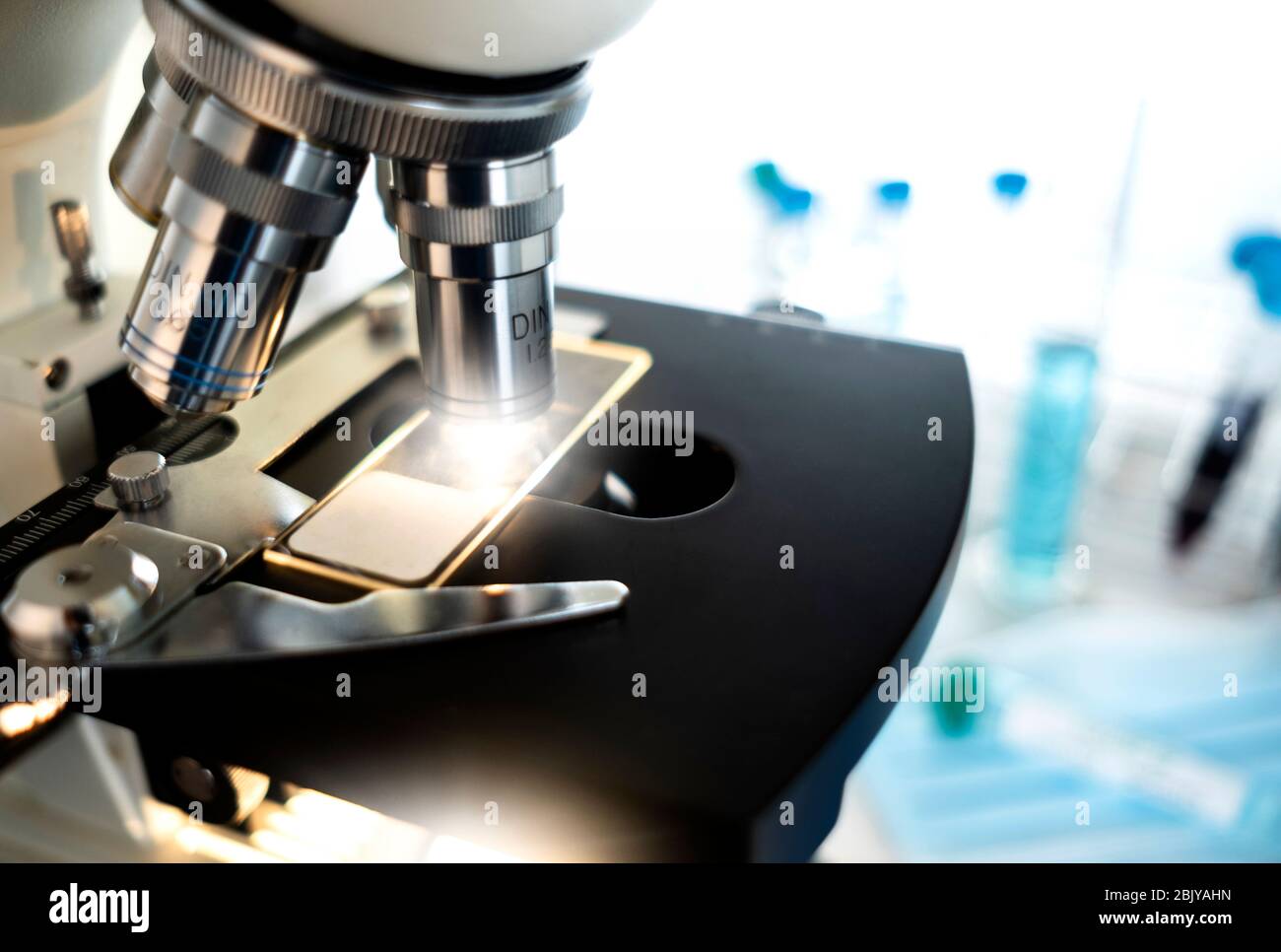 Laboratory microscope with a slide and vial of coronavirus test Stock ...