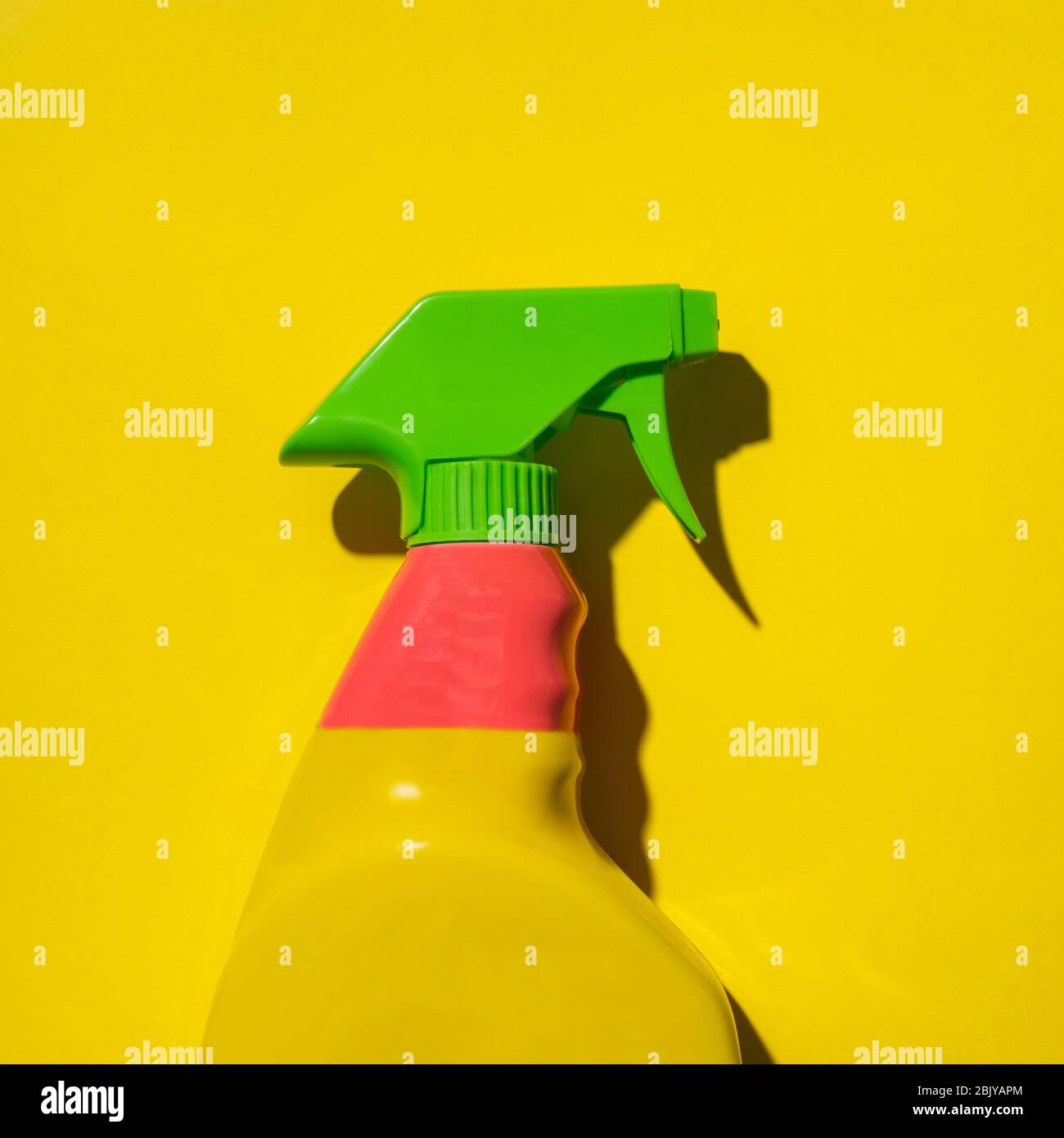 Colorful plastic spray bottle on yellow background Stock Photo - Alamy