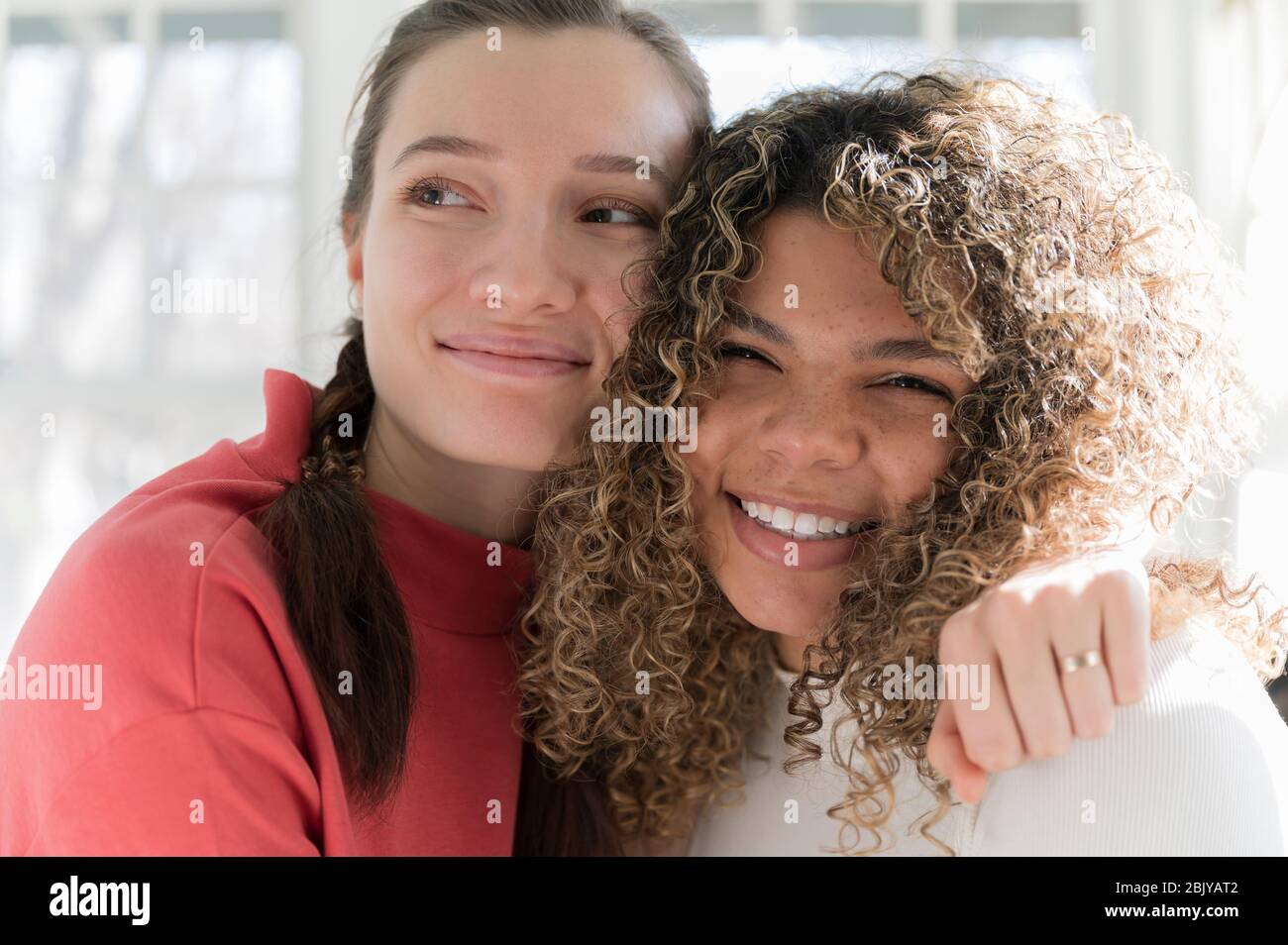 Portrait of embracing friends Stock Photo - Alamy