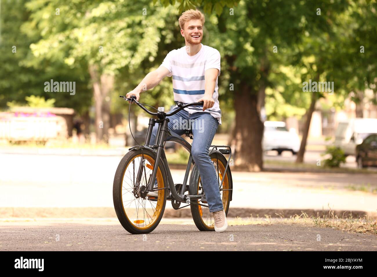 Young man riding bicycle outdoors Stock Photo - Alamy