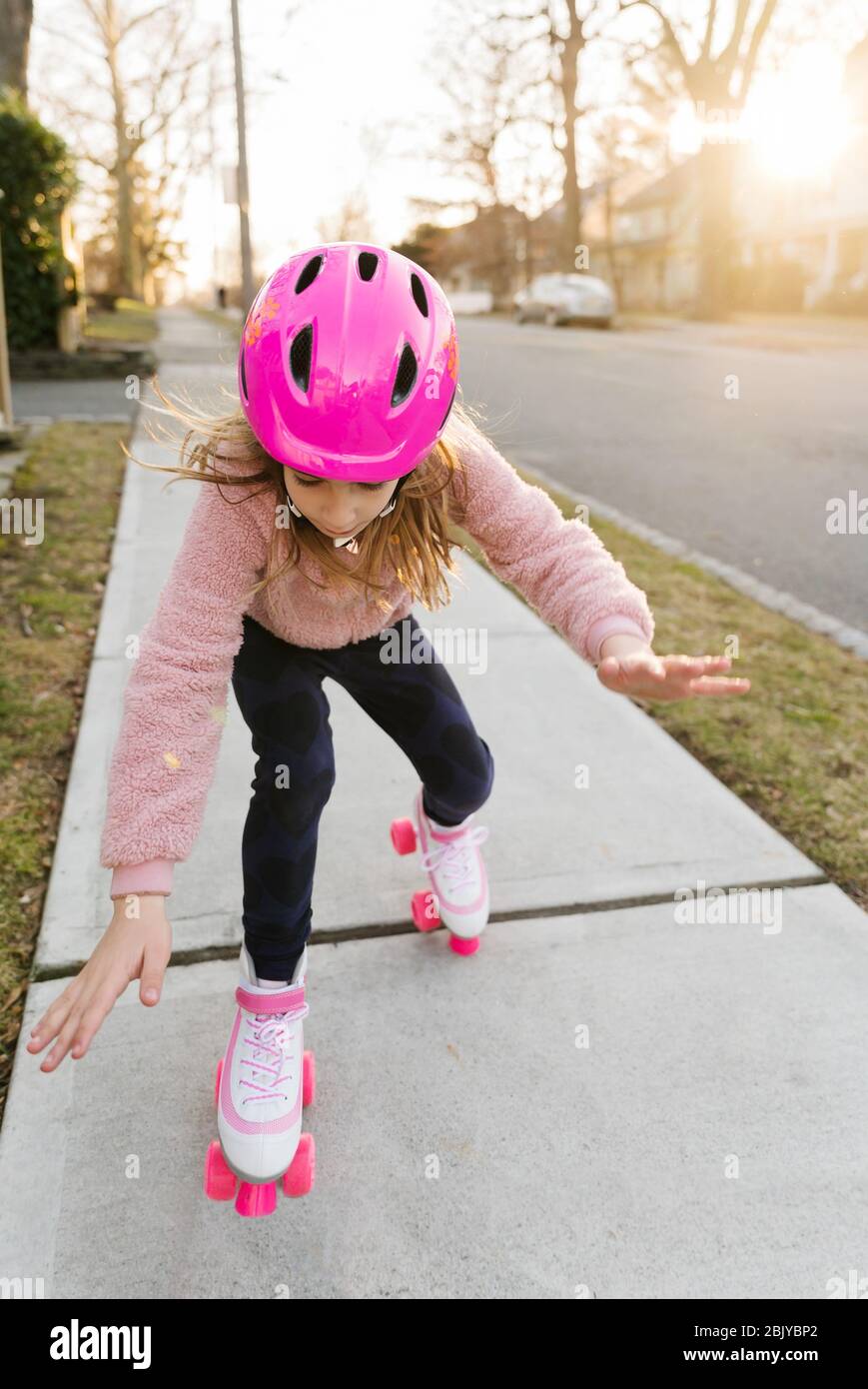 Rollerskating girl losing balance Stock Photo - Alamy