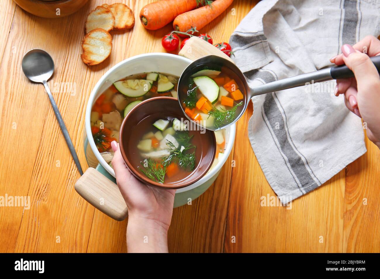 Pouring broth into pot hi-res stock photography and images - Alamy