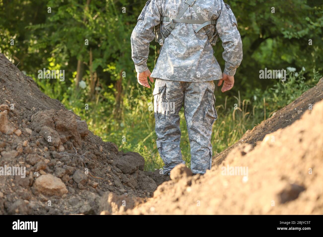 Male soldier in fighting position, back view Stock Photo - Alamy