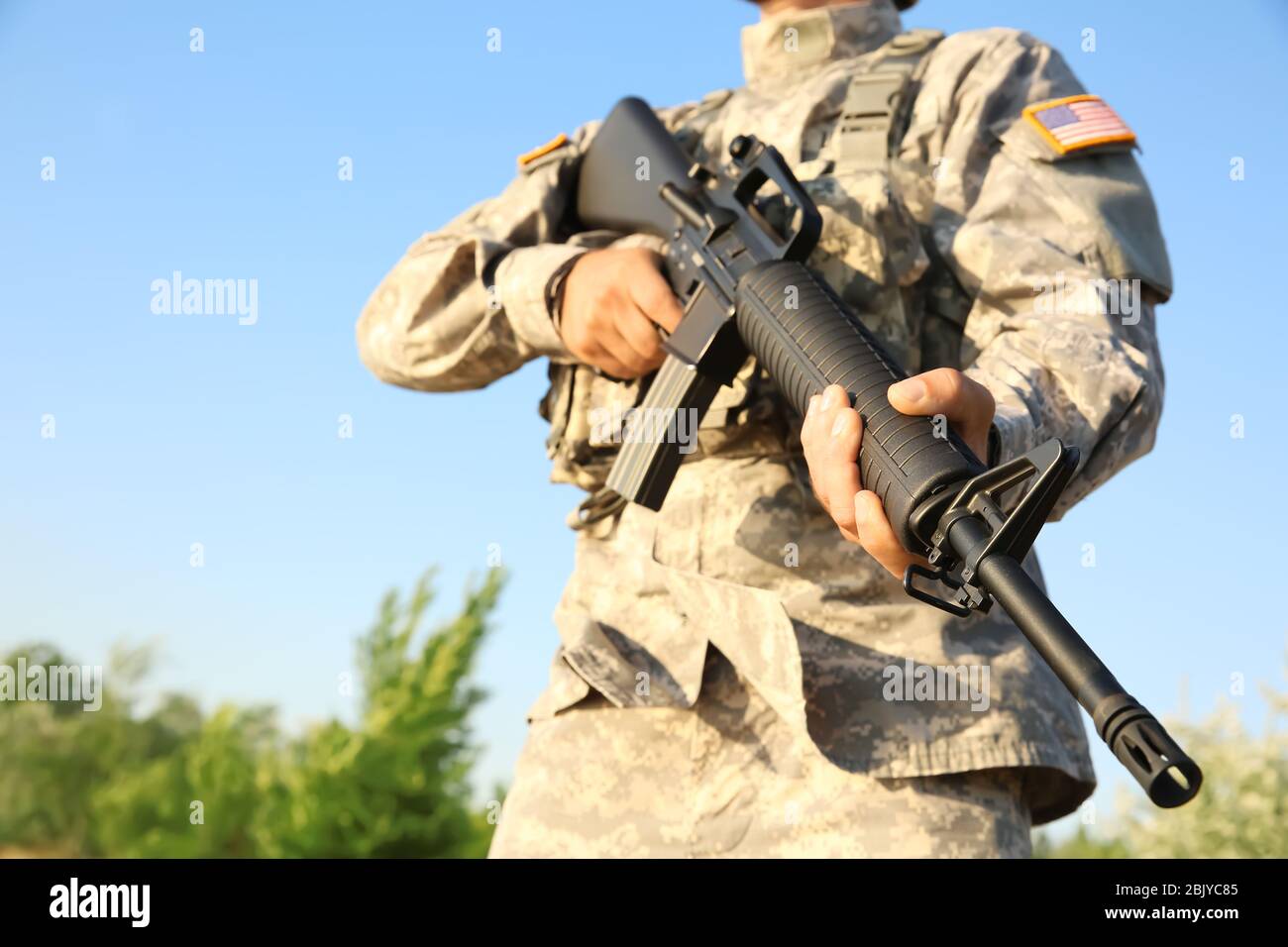 Soldier in camouflage with assault rifle outdoors Stock Photo - Alamy
