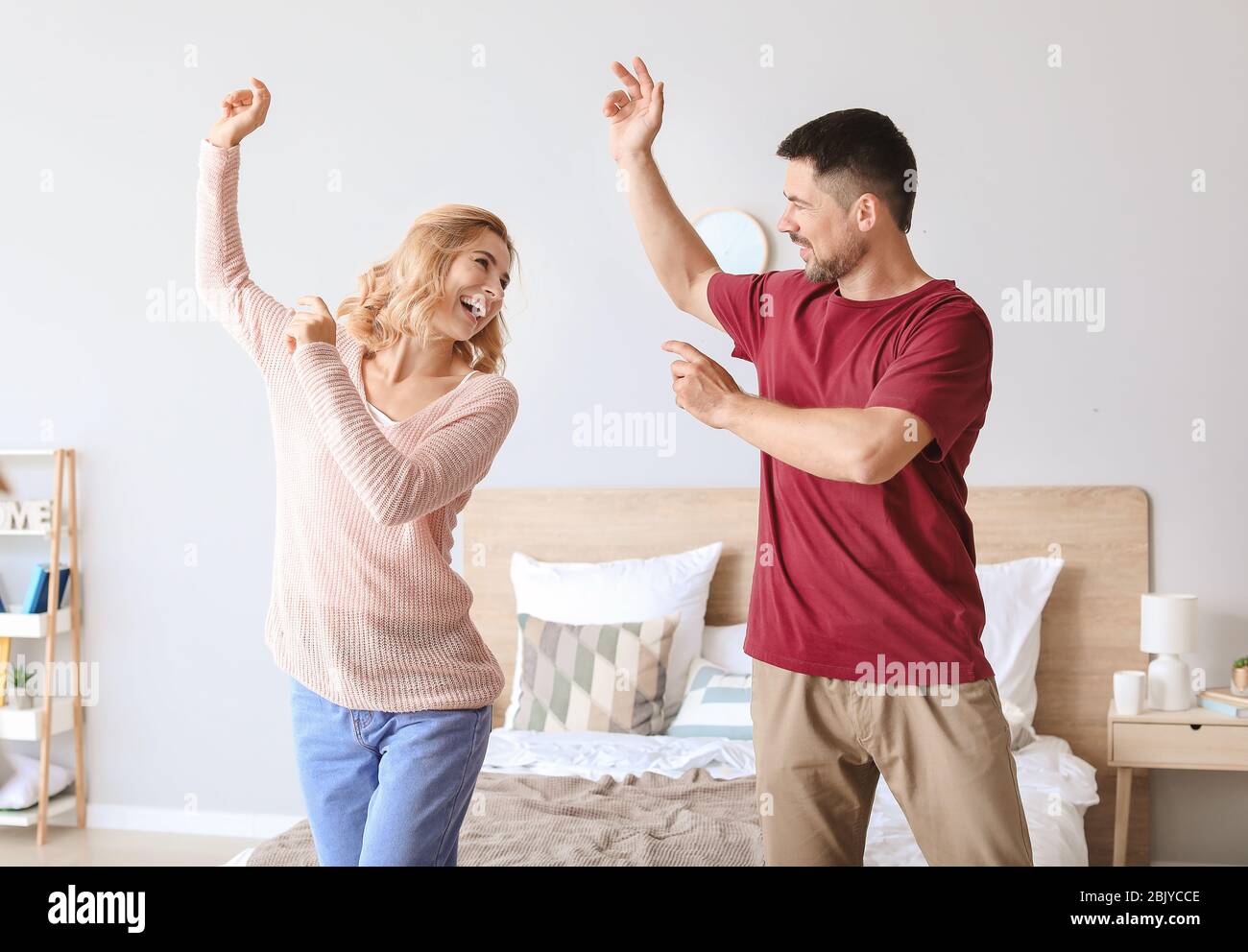 Happy couple dancing in bedroom hi-res stock photography and images - Alamy