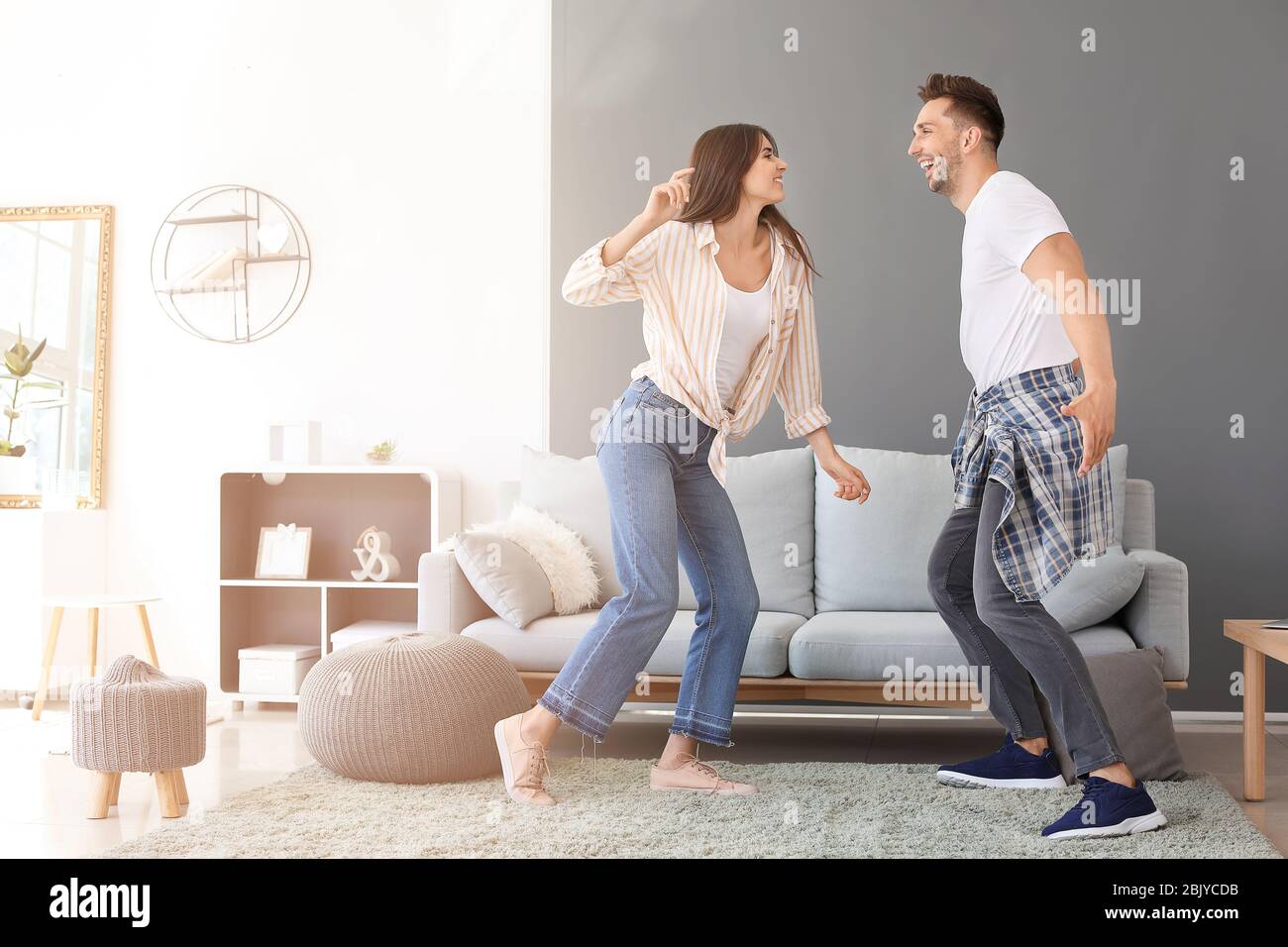 Happy young couple dancing at home Stock Photo - Alamy