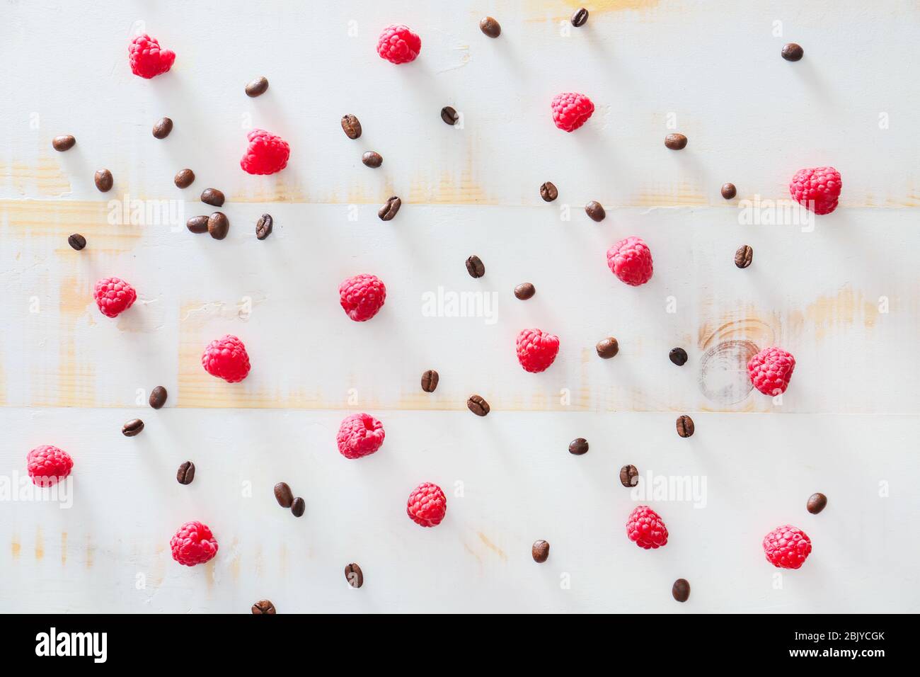 Fresh raspberries with coffee beans on light background Stock Photo - Alamy