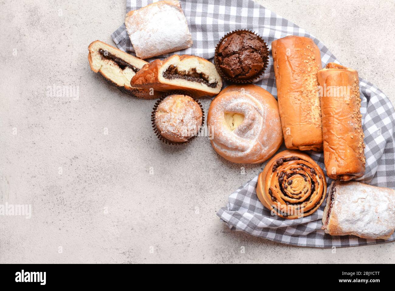 Heap of tasty pastries on grey background Stock Photo - Alamy