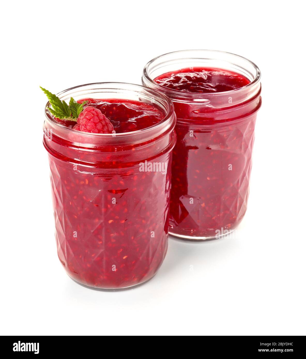 Jars of tasty raspberry jam on white background Stock Photo - Alamy