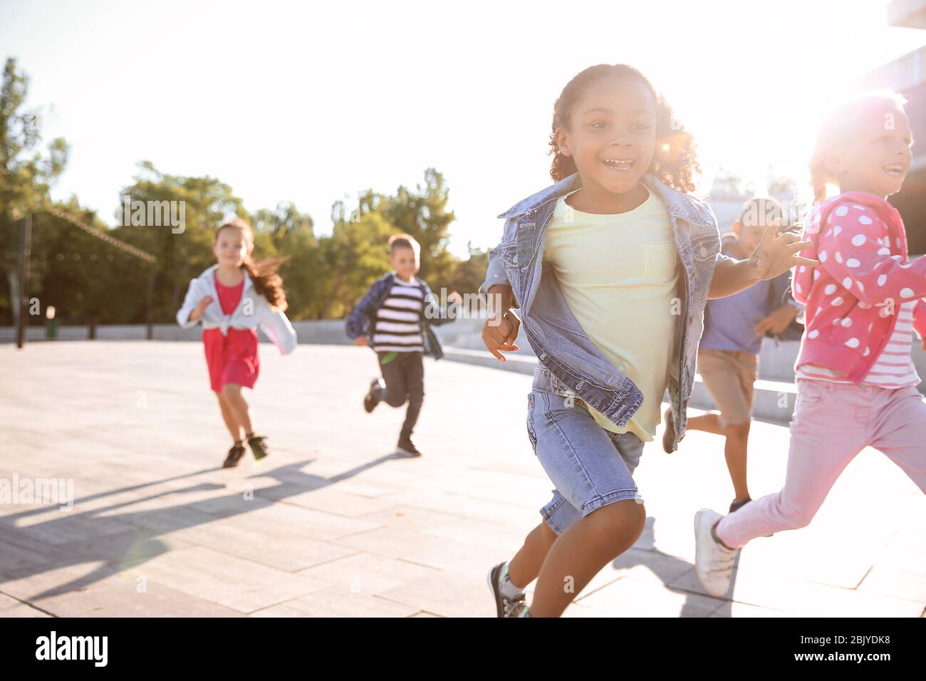 Group of running children outdoors Stock Photo - Alamy