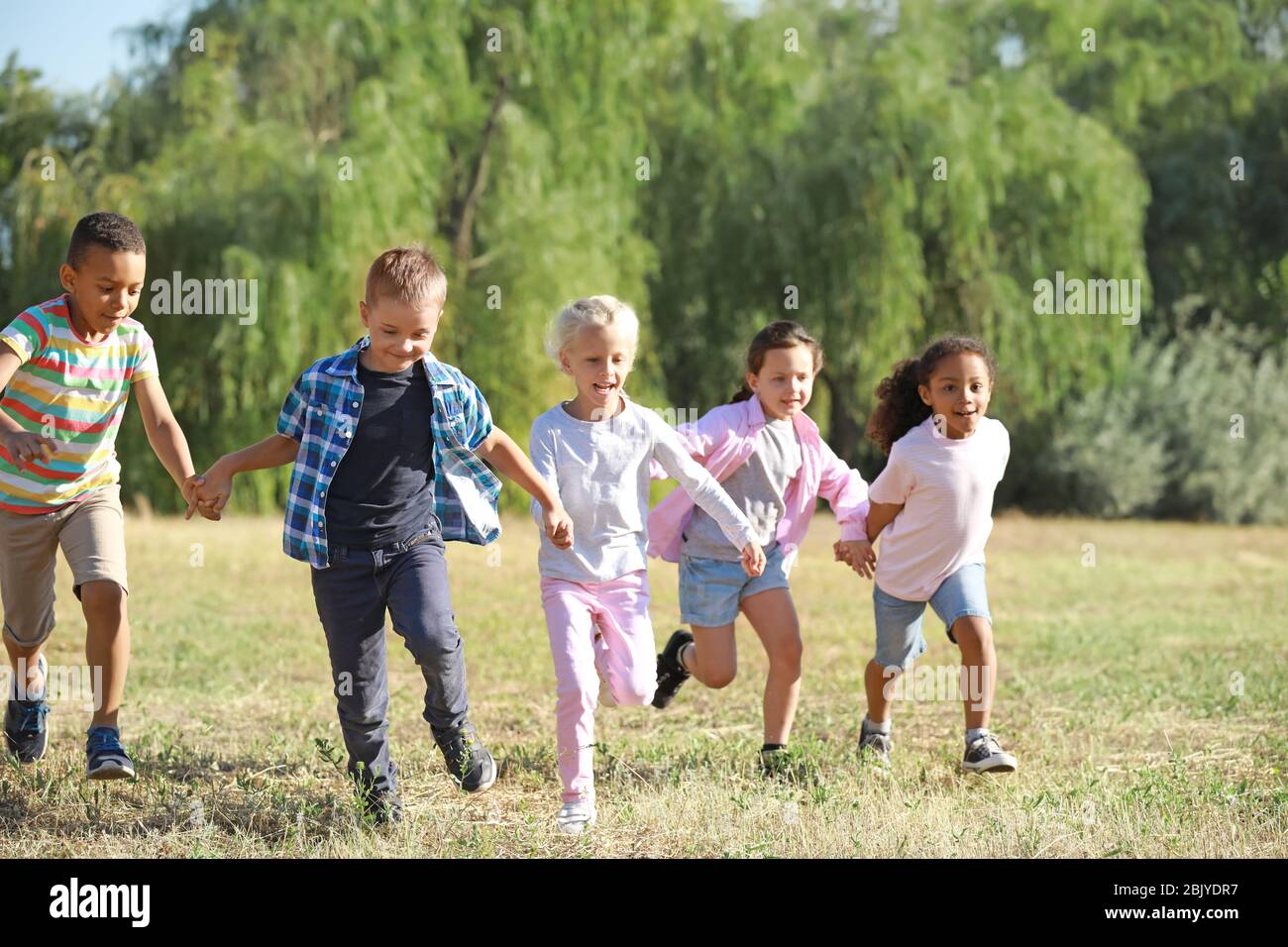 Group of running children in park Stock Photo - Alamy