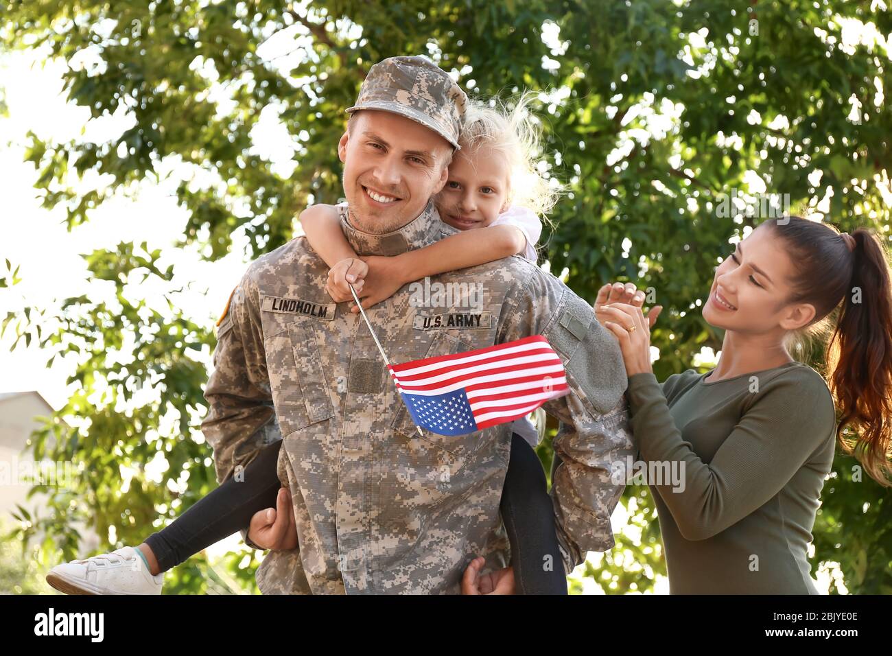 Happy military man with his family outdoors Stock Photo - Alamy