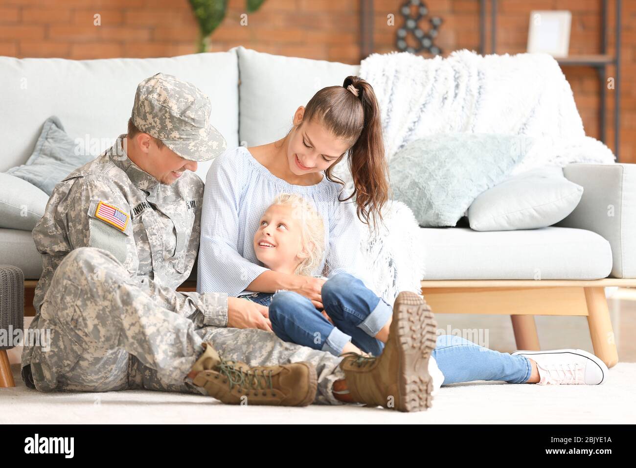 Happy military man with his family at home Stock Photo - Alamy