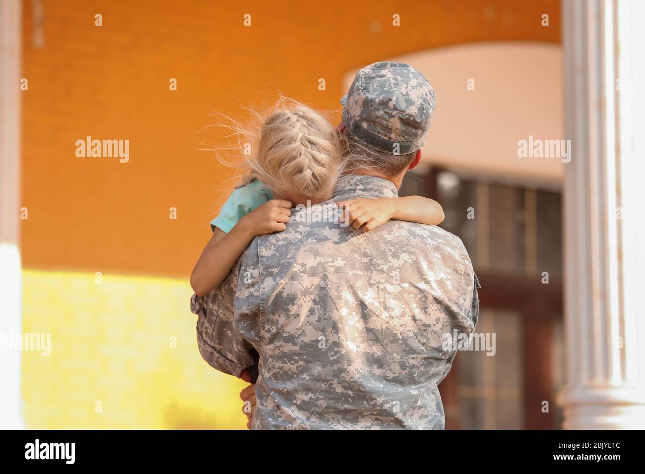 Military man hugging his little daughter outdoors Stock Photo - Alamy