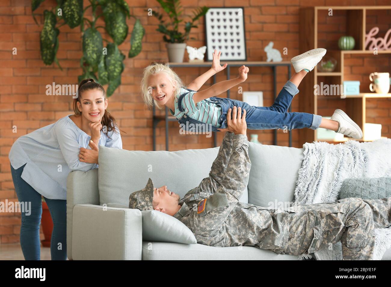 Happy military man with his family at home Stock Photo - Alamy
