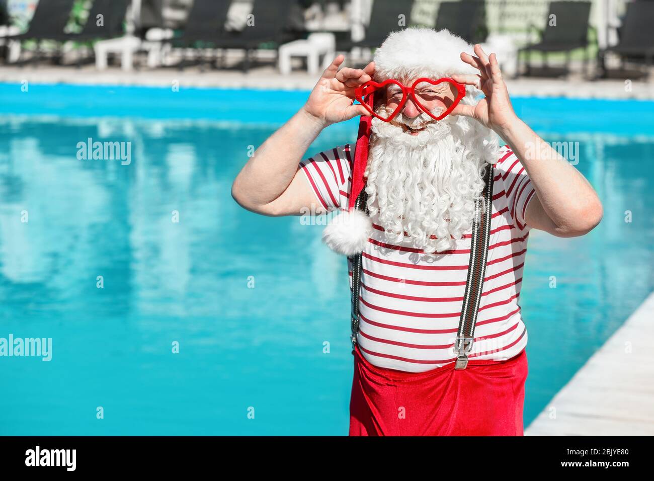 Santa Claus near swimming pool at resort Stock Photo - Alamy