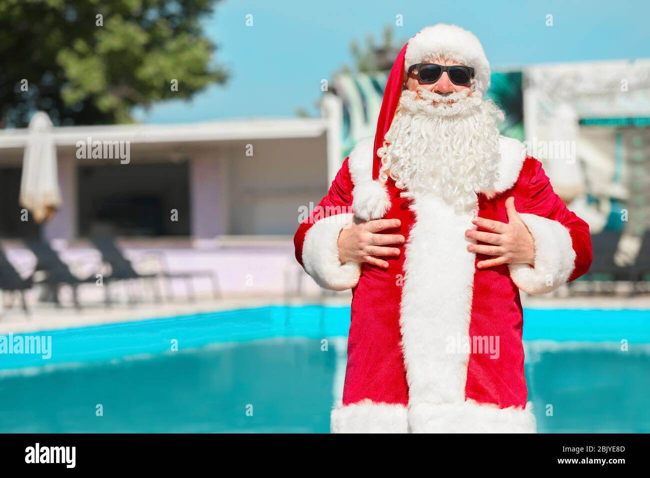 Santa Claus near swimming pool at resort Stock Photo - Alamy