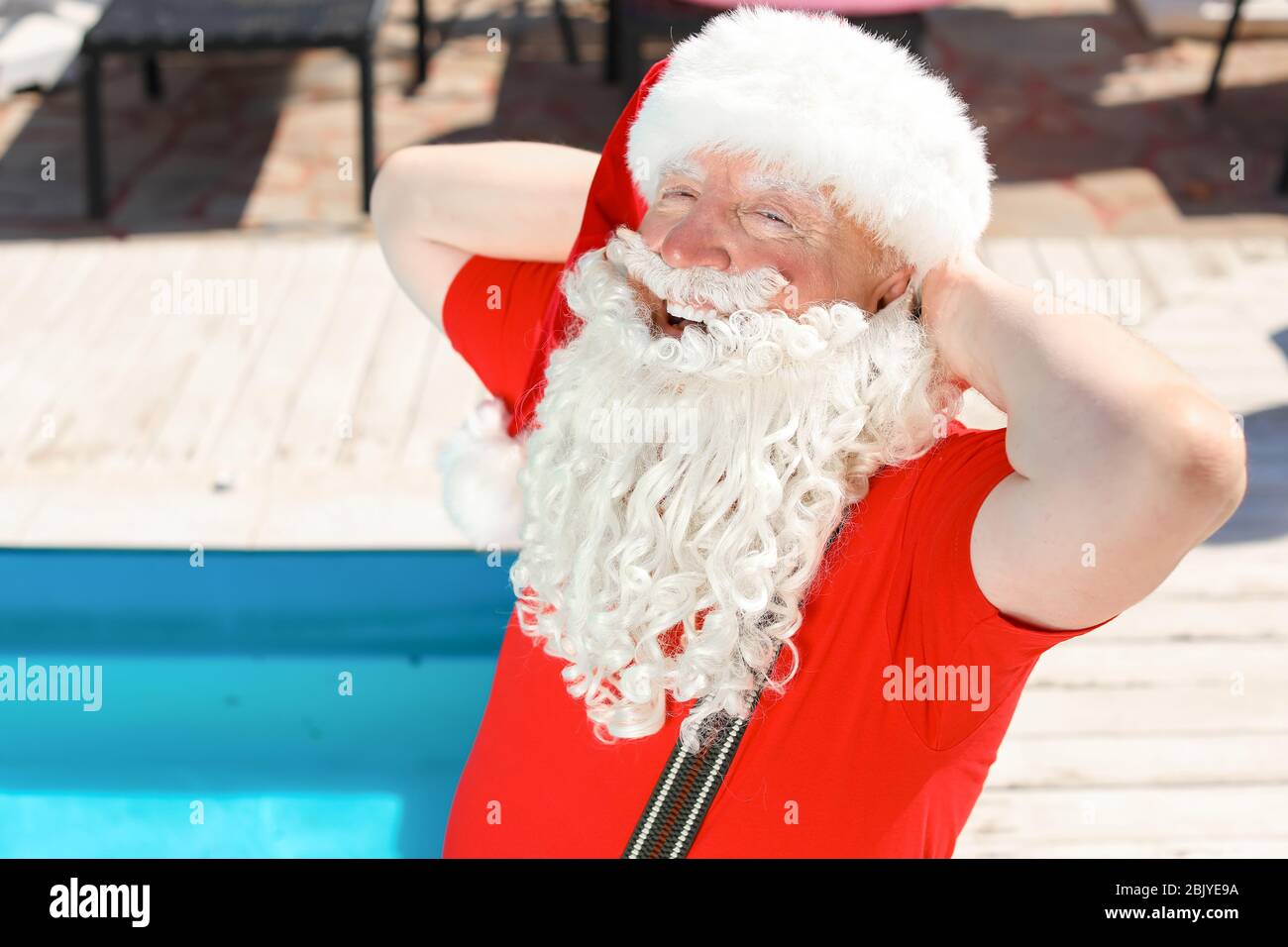 Santa Claus near swimming pool at resort Stock Photo - Alamy