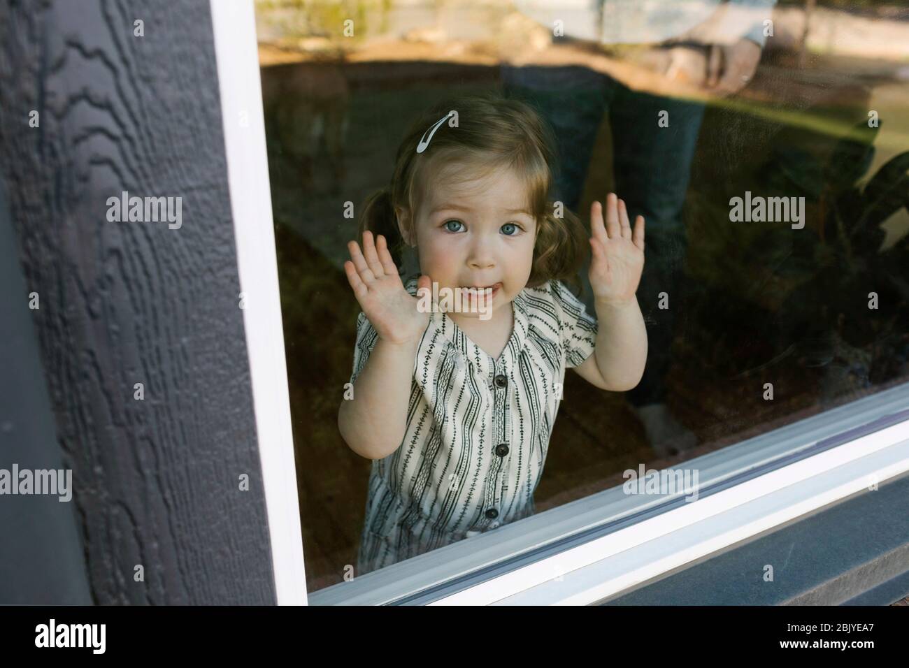Girl looking through a window hi-res stock photography and images - Alamy