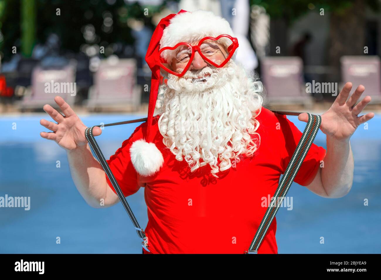 Santa Claus near swimming pool at resort Stock Photo - Alamy