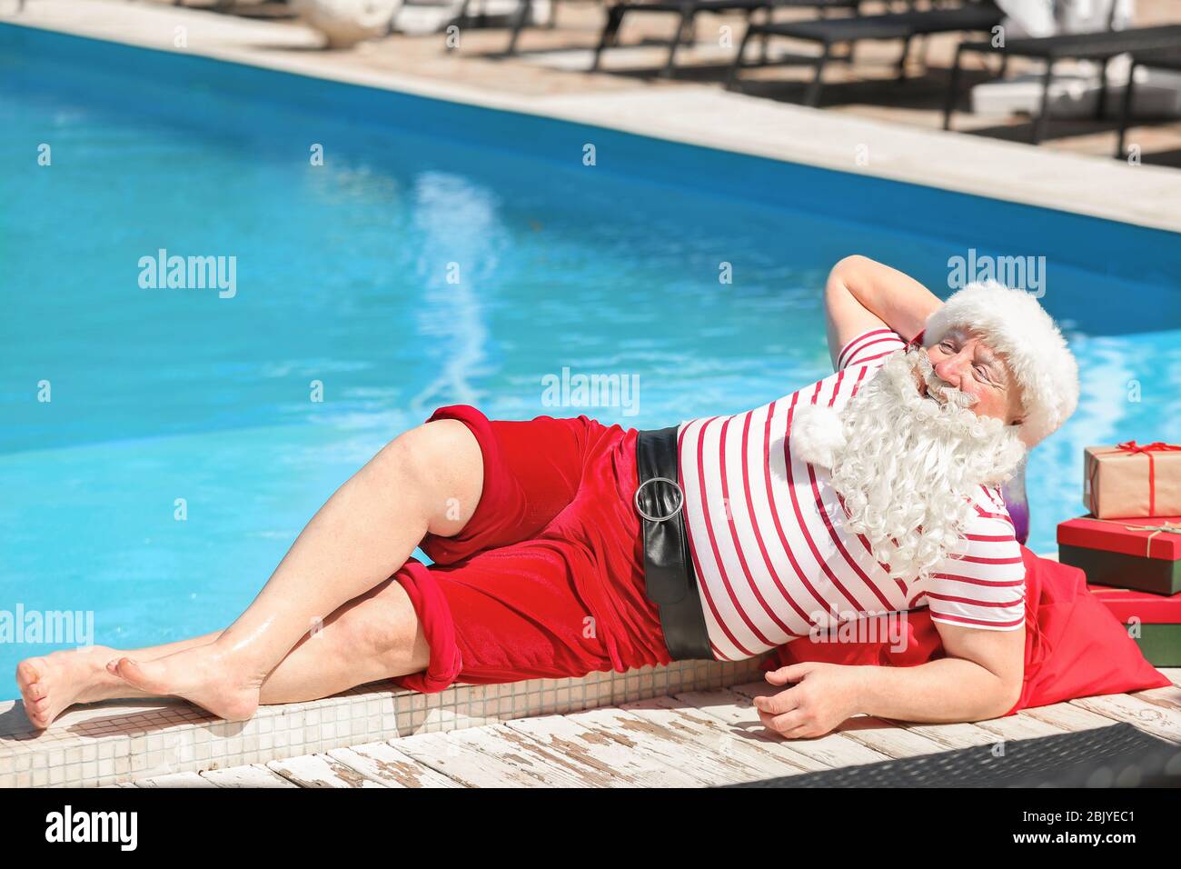 Santa Claus near swimming pool at resort Stock Photo - Alamy