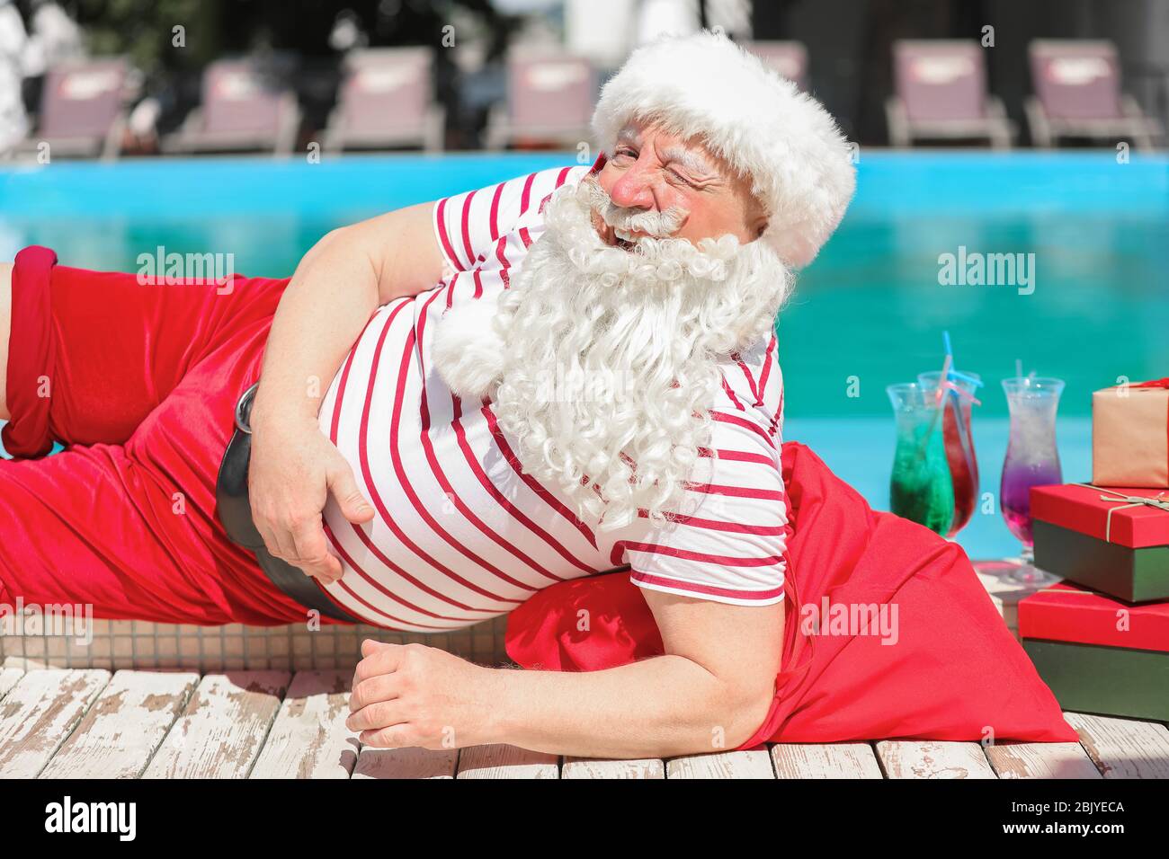 Santa Claus near swimming pool at resort Stock Photo - Alamy
