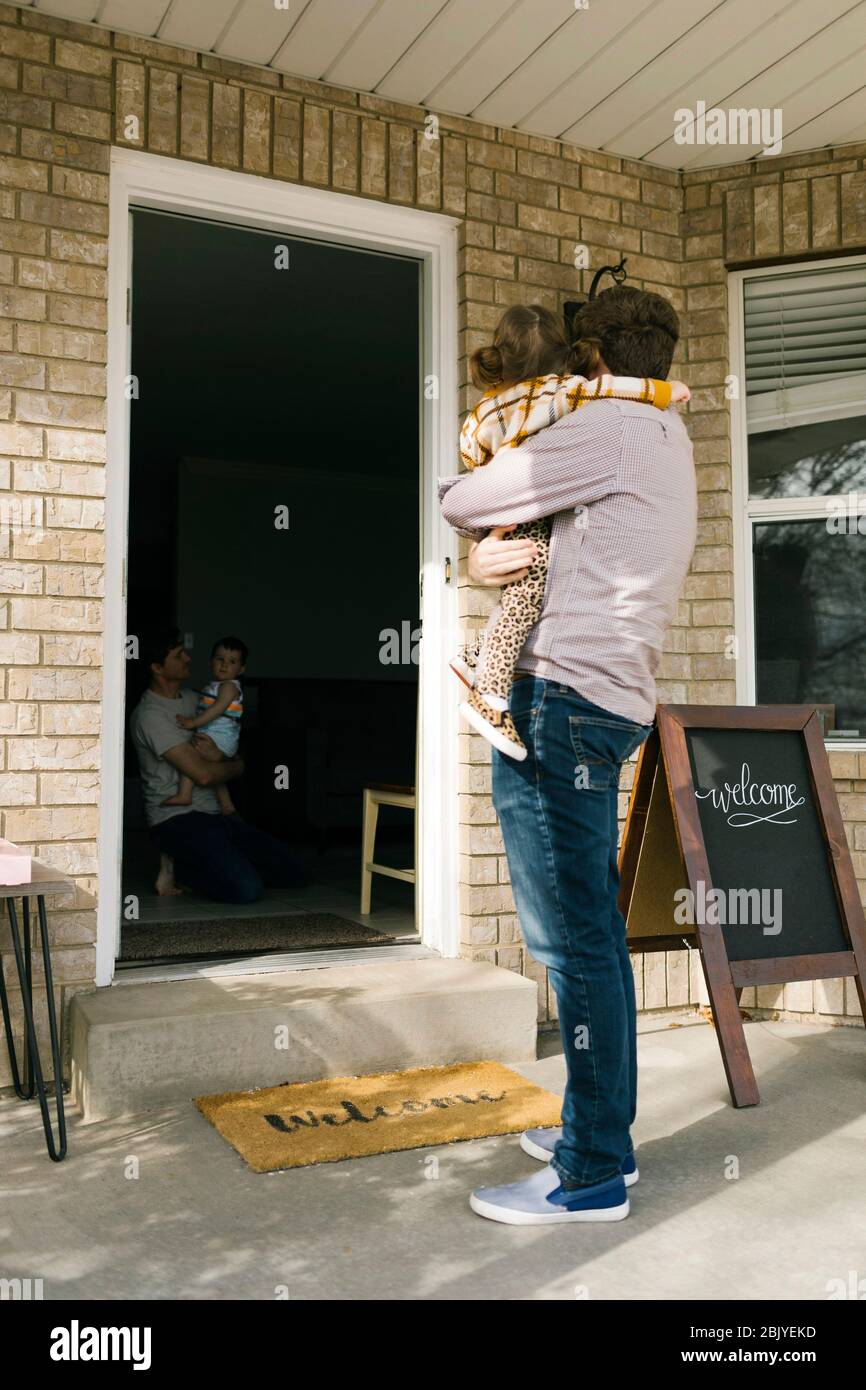 Father with daughter (2-3) visiting friends while keeping distance ...
