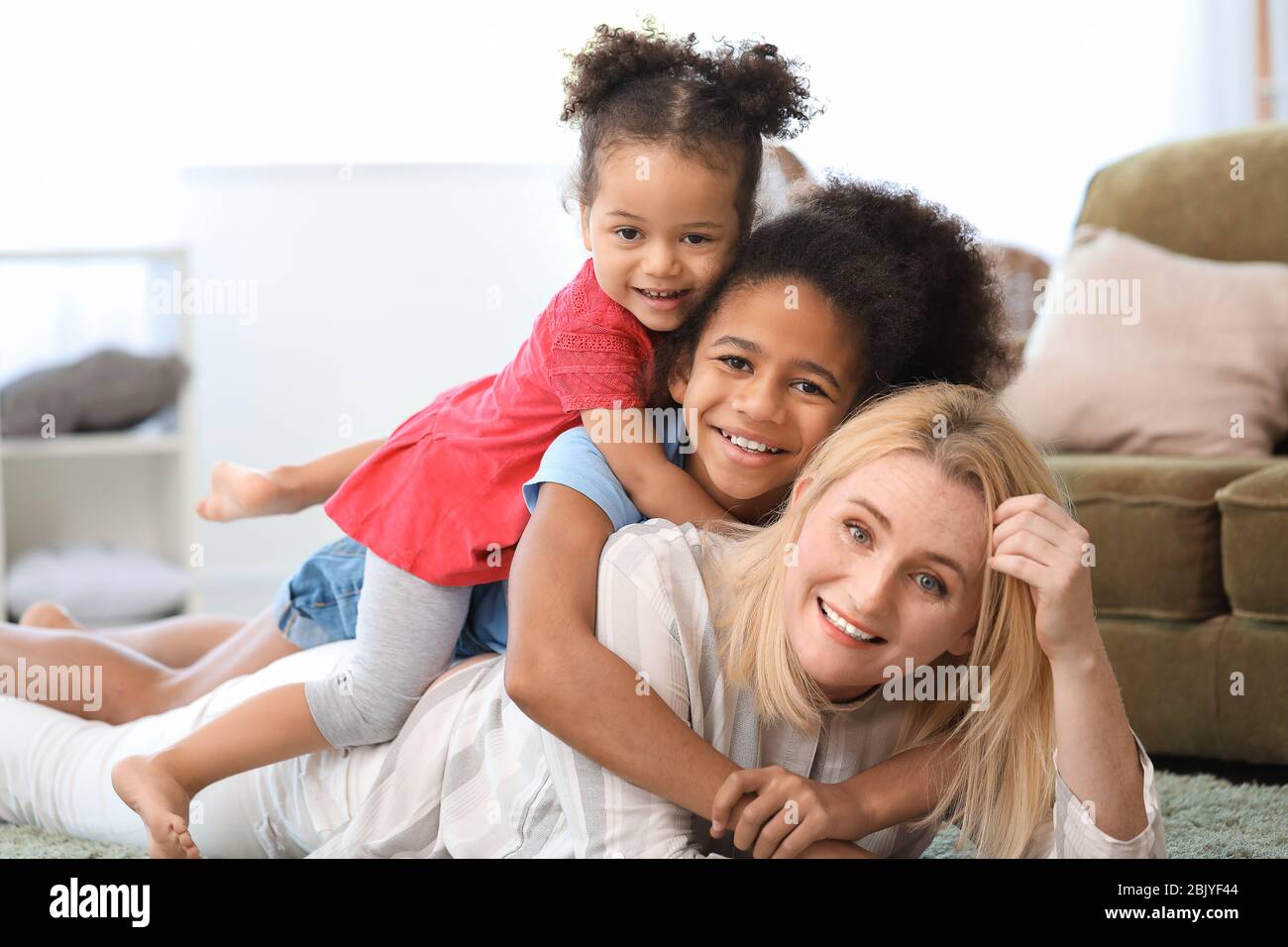 Happy woman with her African-American daughters at home Stock Photo - Alamy