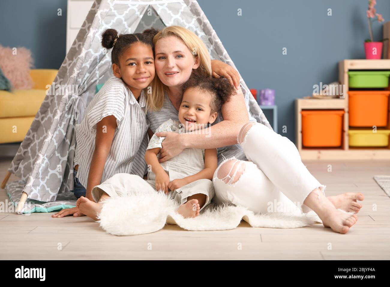 Happy woman with her African-American daughters at home Stock Photo - Alamy