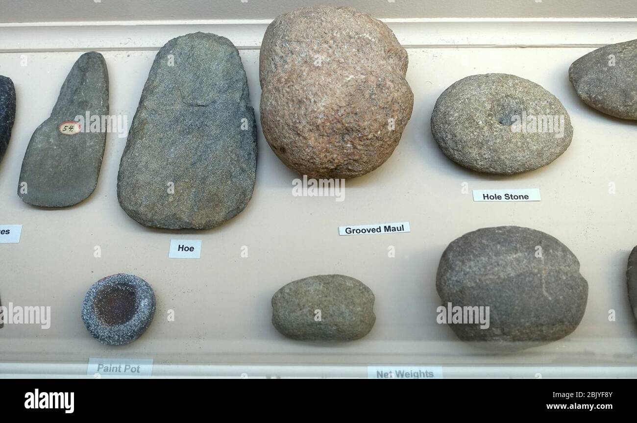 Hoe, grooved maul, hole stone, paint pot, and net weights Stock Photo ...