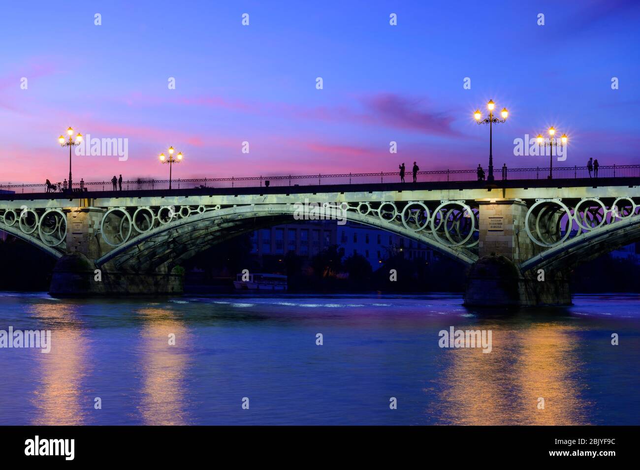 TRIANA BRIDGE AT DUSK, SEVILLE, ANDALUSIA, SPAIN Stock Photo - Alamy