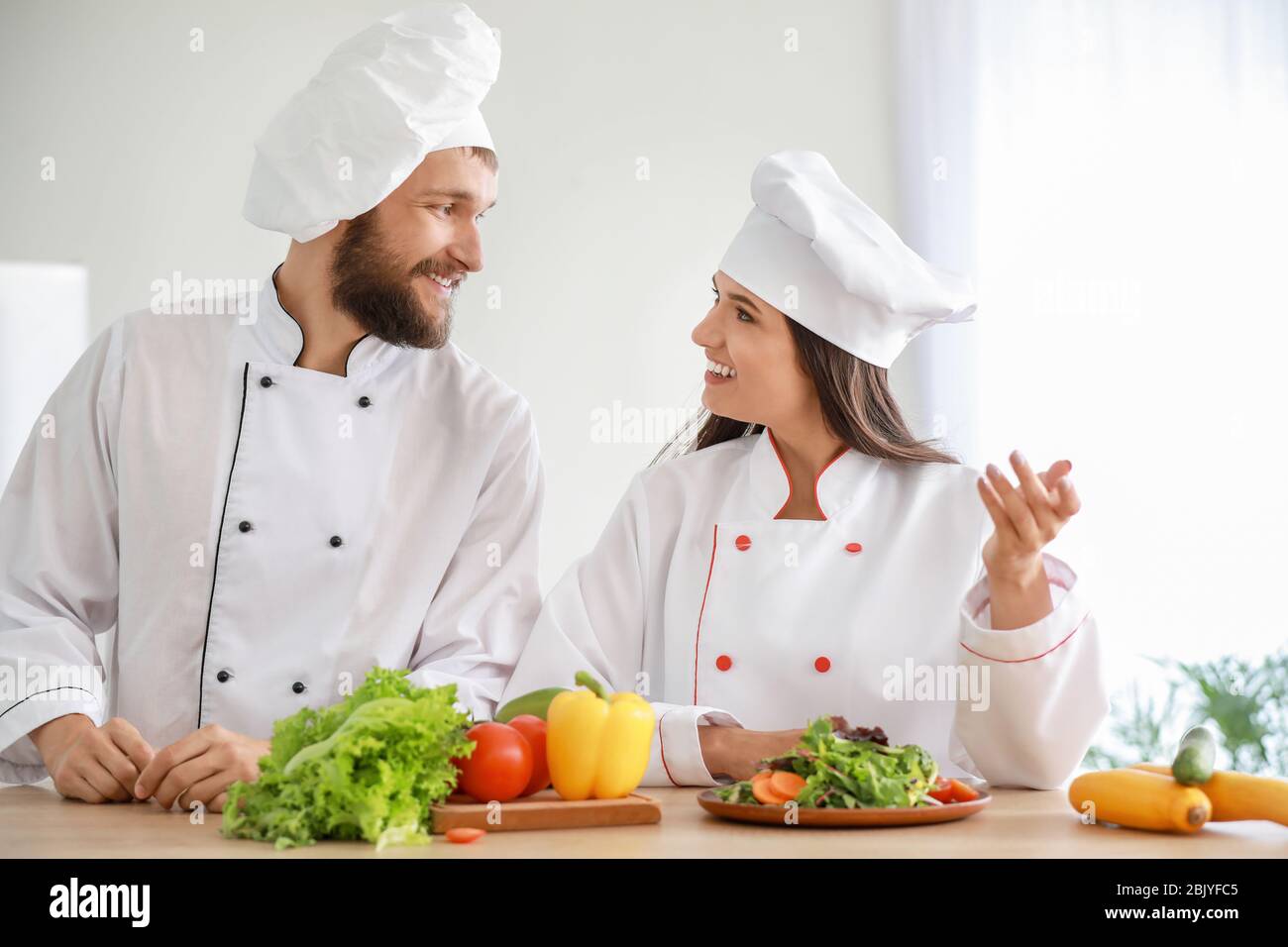 Professional chefs preparing vegetable salad in kitchen Stock Photo - Alamy