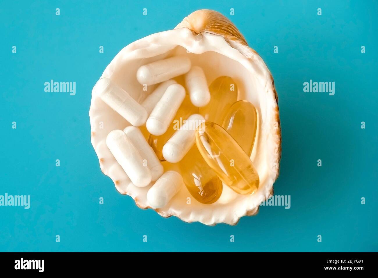 Omega 3 and vitamin D capsules on shell, fish oil pills Stock Photo - Alamy