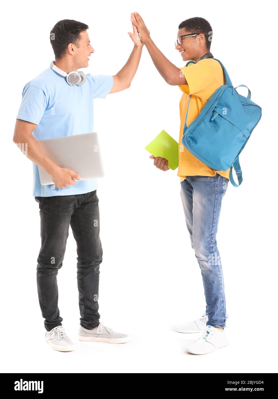 Portrait of young students giving each other high-five on white ...