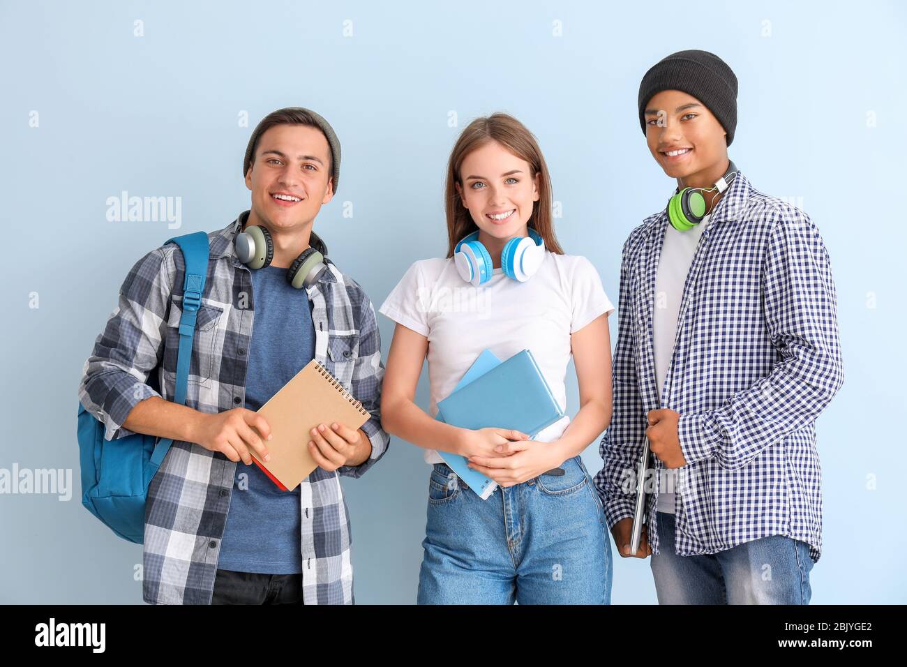 Portrait of young students on color background Stock Photo - Alamy
