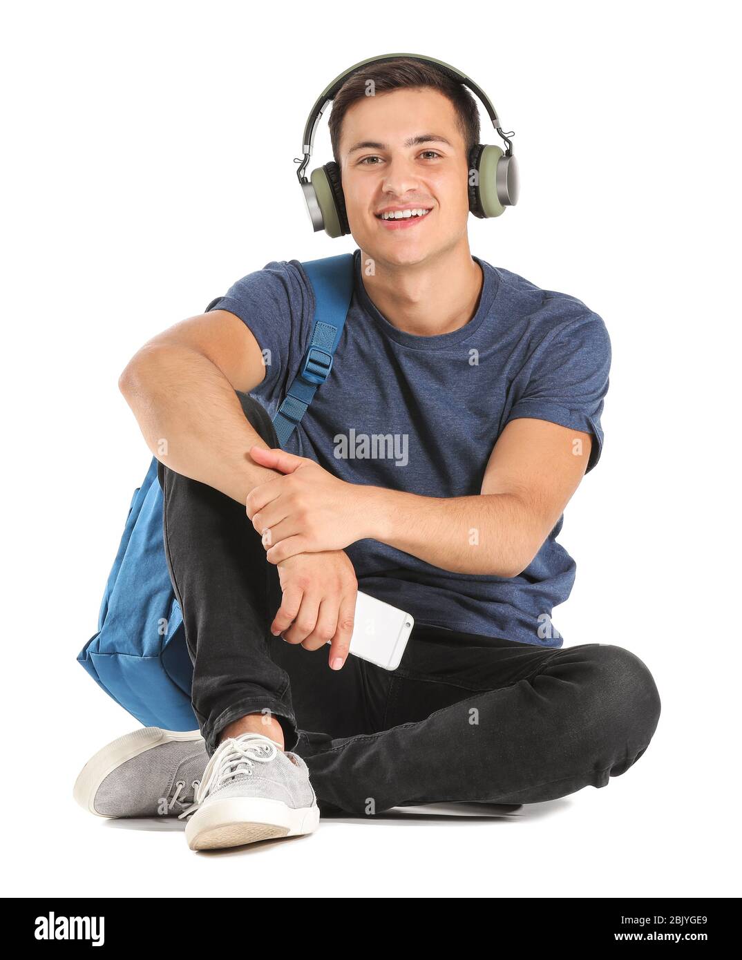 Portrait of young student with headphones on white background Stock ...