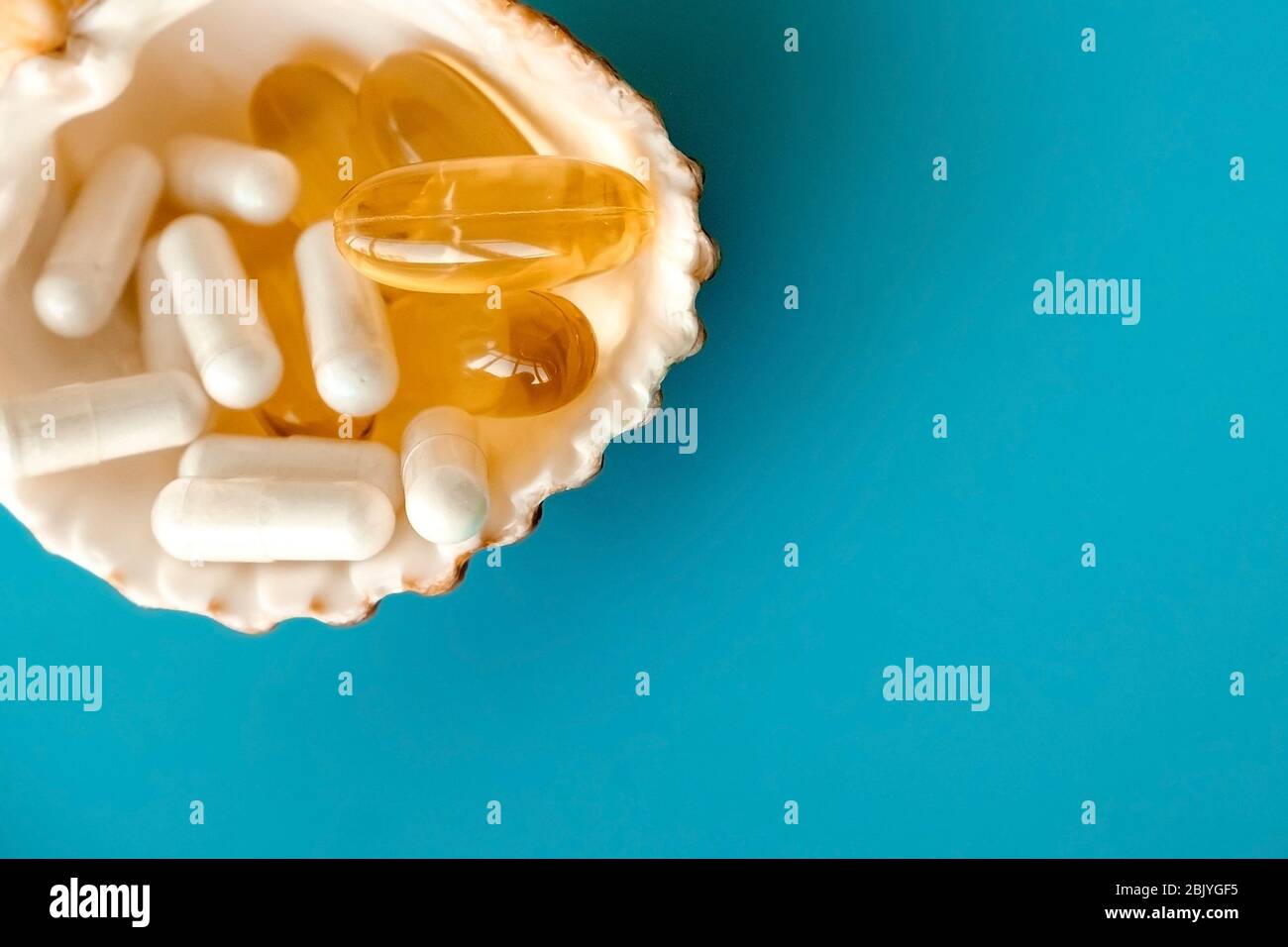 Omega 3 and vitamin D capsules on shell, fish oil pills Stock Photo - Alamy