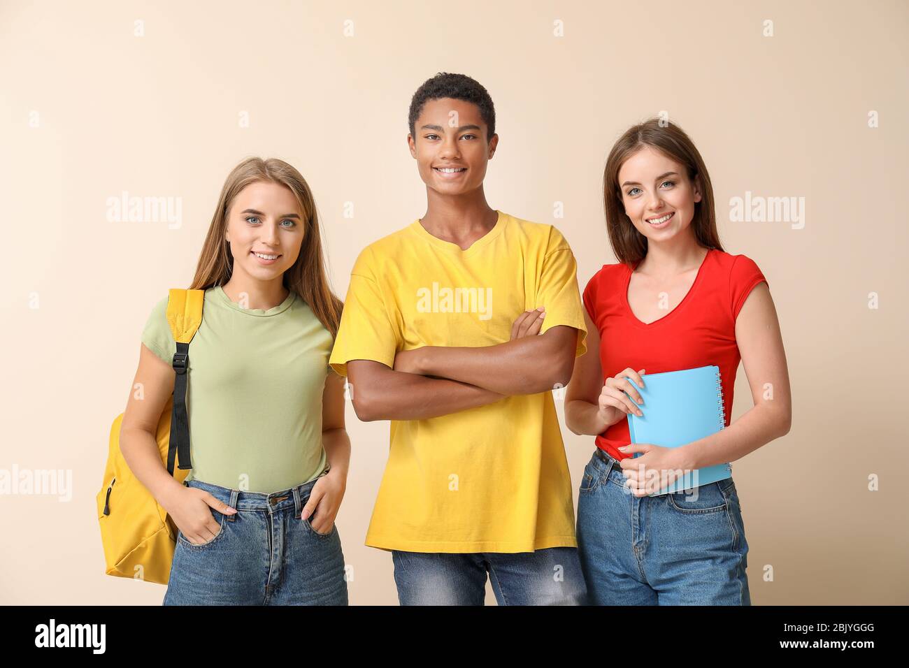 Portrait of young students on light background Stock Photo - Alamy