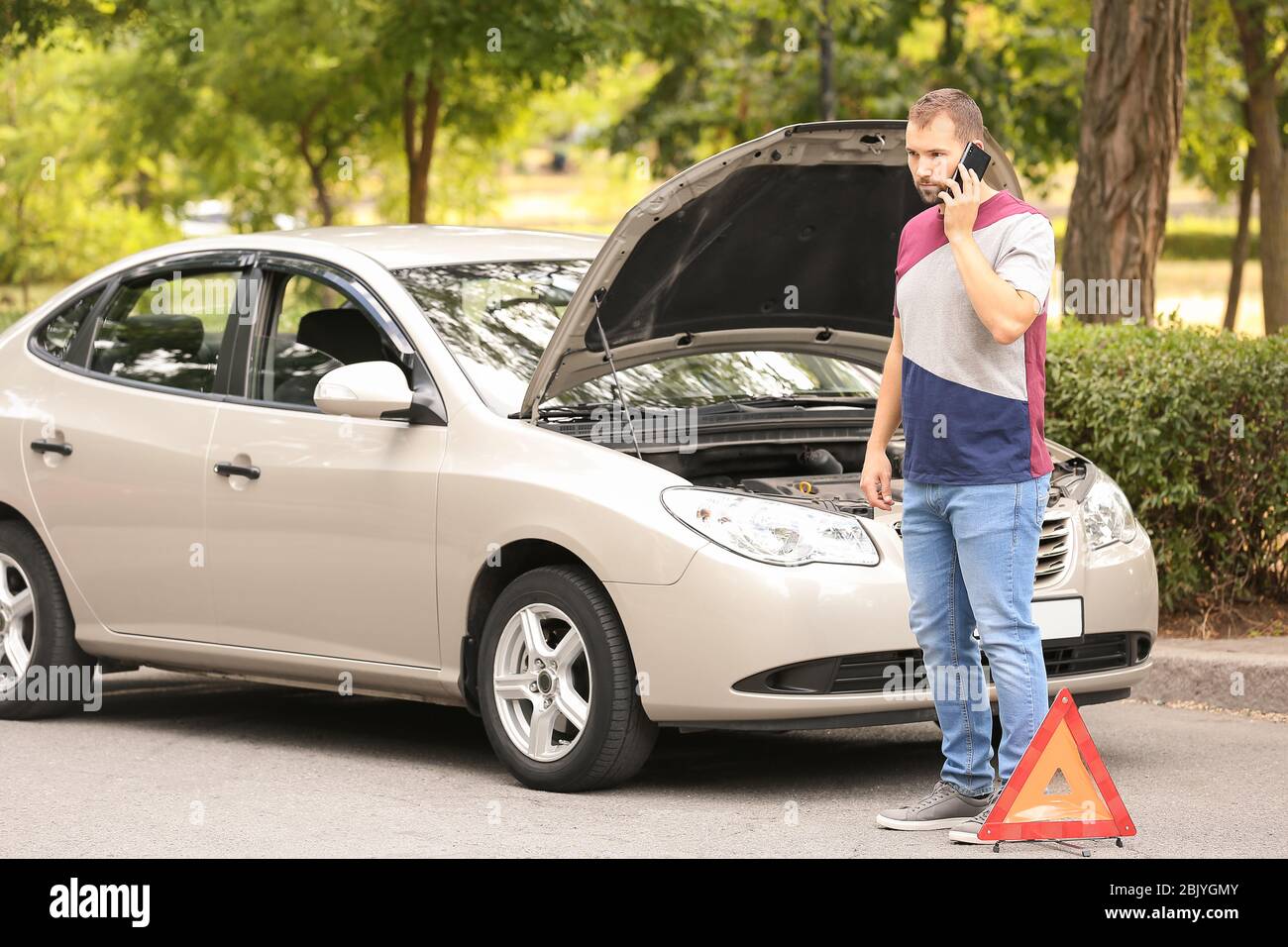 Car standing near stop sign hi-res stock photography and images - Alamy