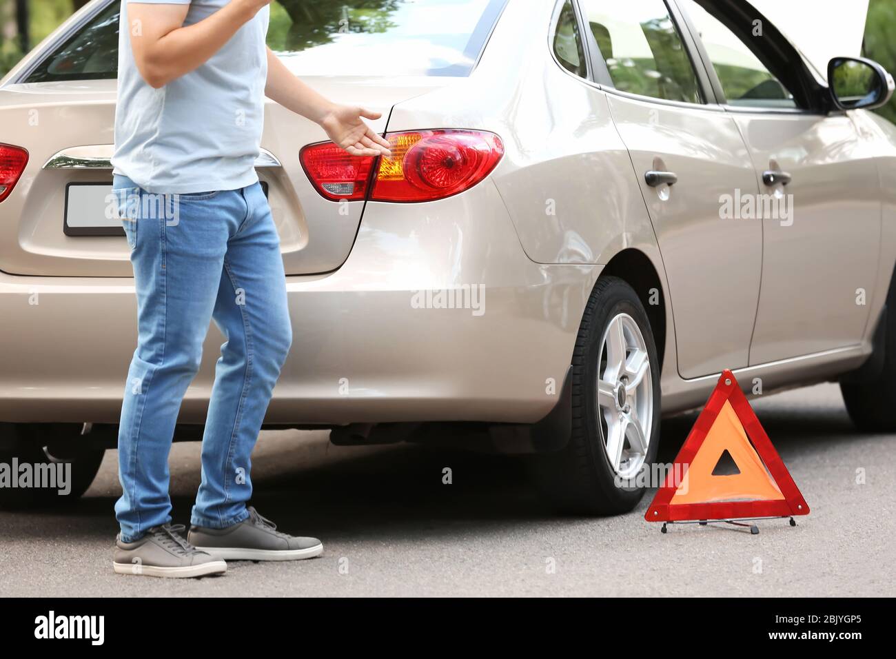 Car standing near stop sign hi-res stock photography and images - Alamy