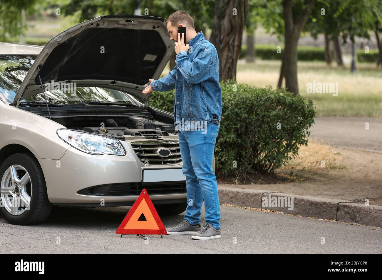 Car standing near stop sign hi-res stock photography and images - Alamy