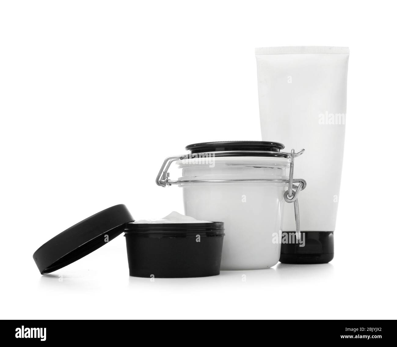 Different body cream on white background Stock Photo - Alamy