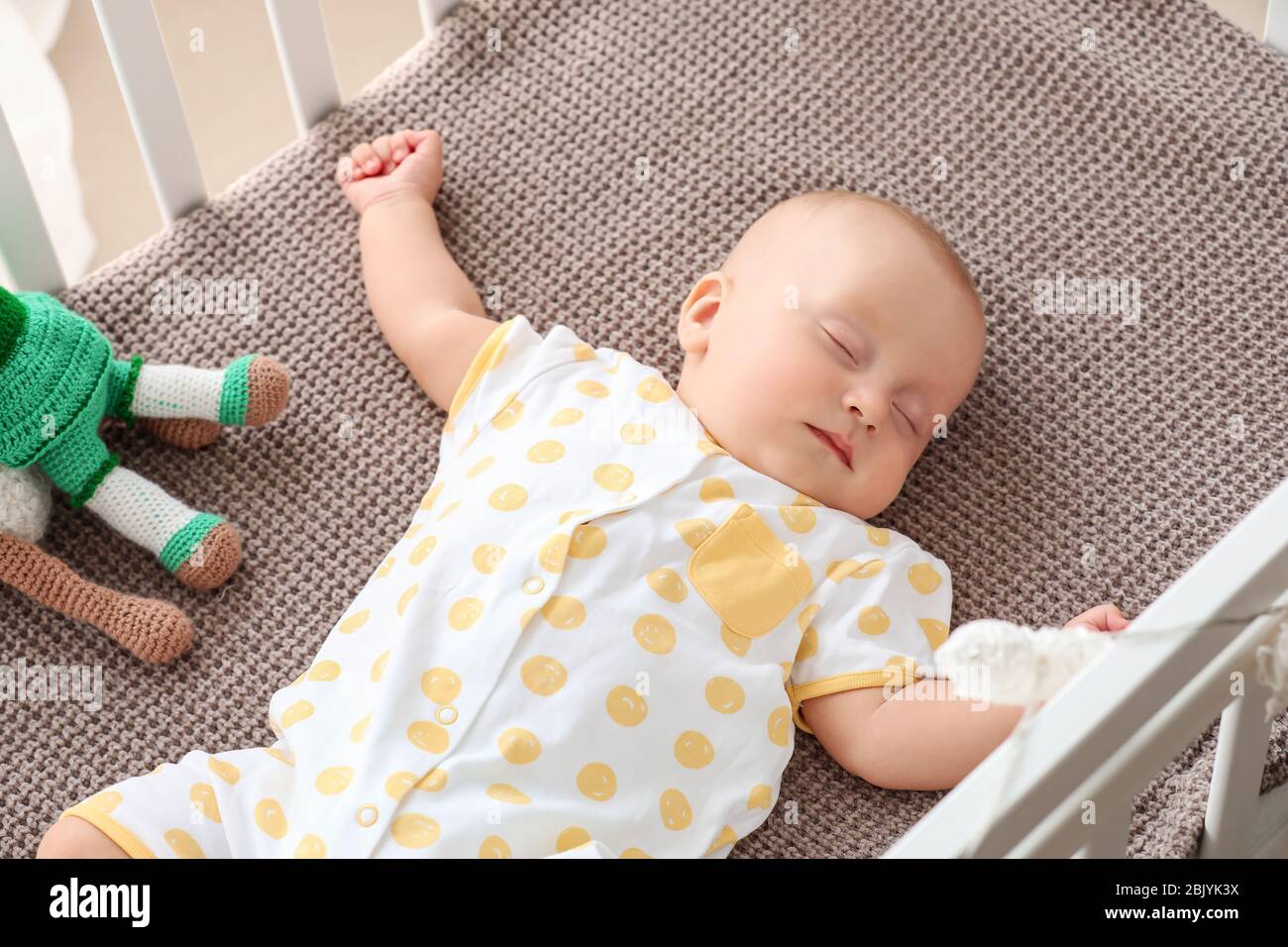 Adorable little baby sleeping in crib Stock Photo - Alamy