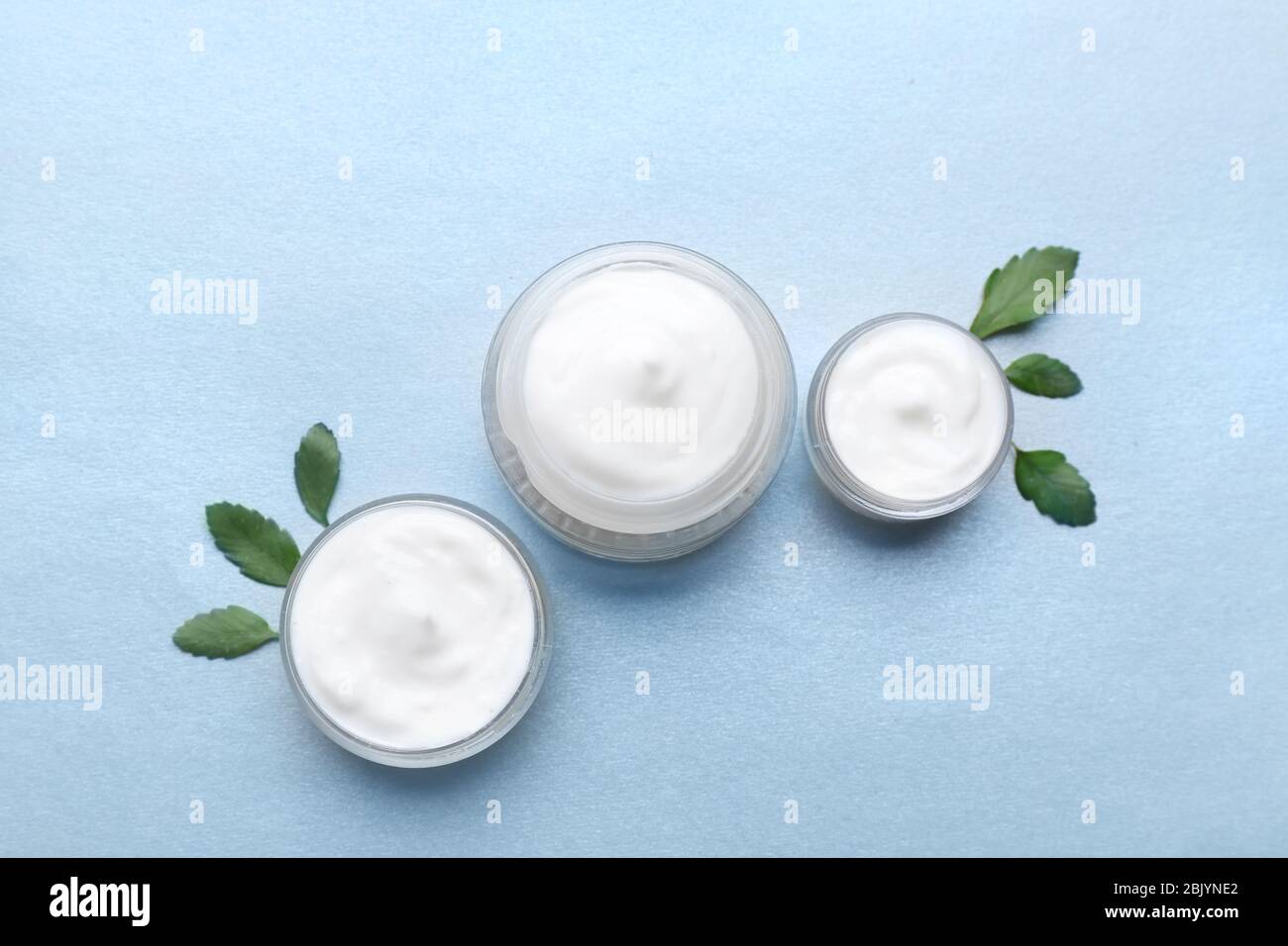 Jars of natural cream on light background Stock Photo - Alamy