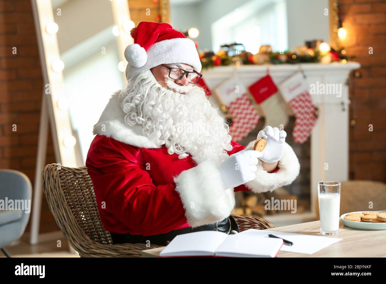 Santa eating cookies hi-res stock photography and images - Alamy