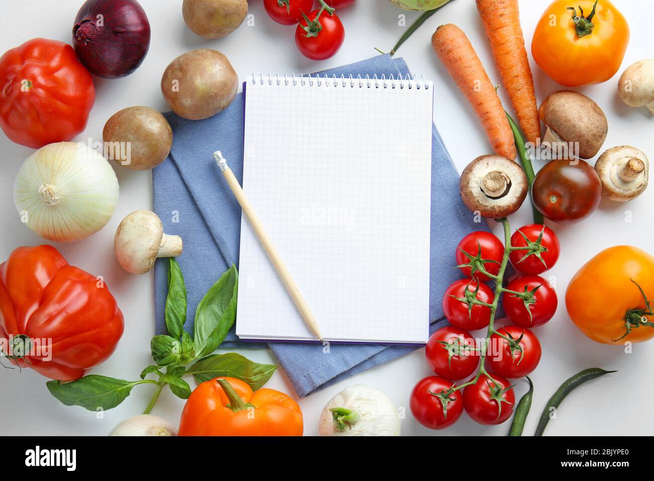 Different fresh vegetables with notebook on white background Stock ...