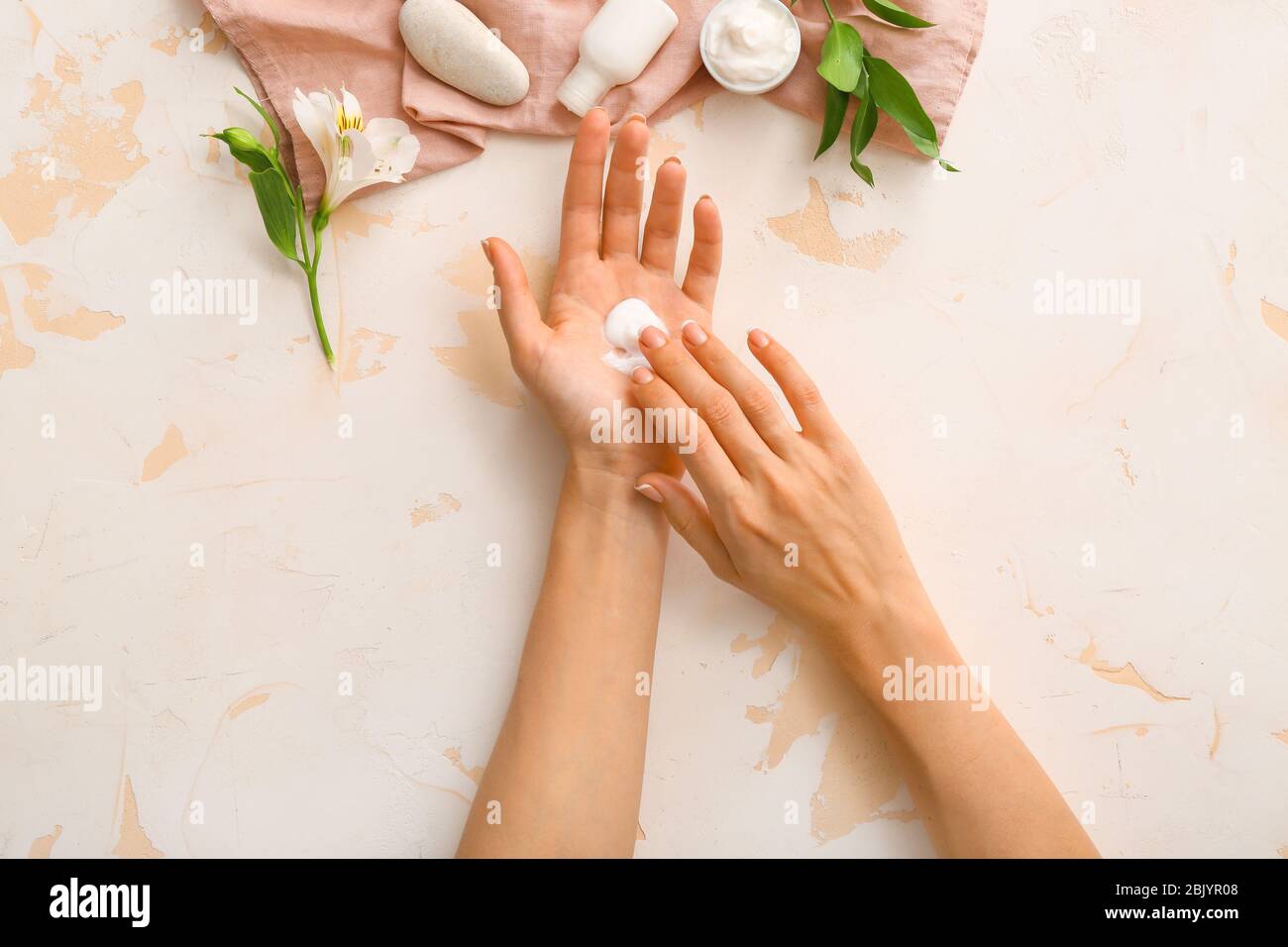 Female hands with natural cream on light background Stock Photo - Alamy