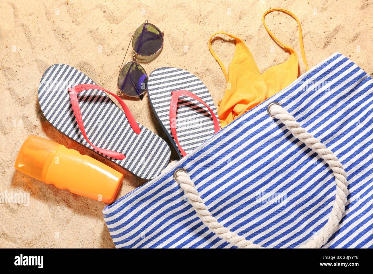 Female beach accessories with cosmetics on sand beach Stock Photo - Alamy